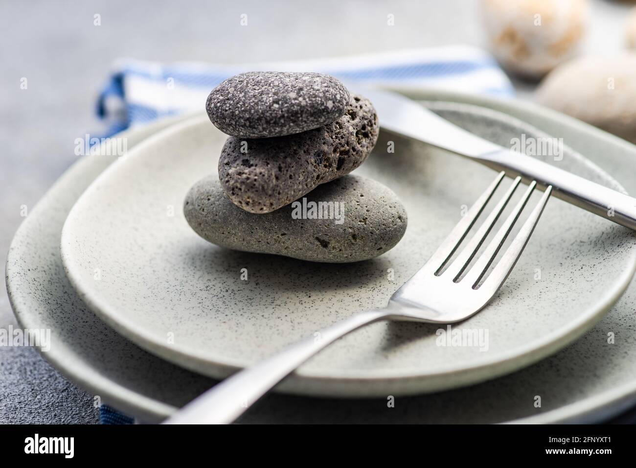 Rustic place setting with pebbles Stock Photo - Alamy