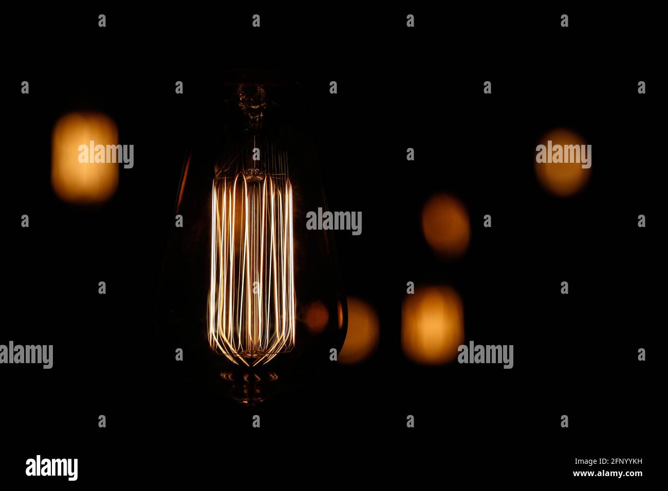 vintage old electric lamp against dark background - ideas concept Stock ...