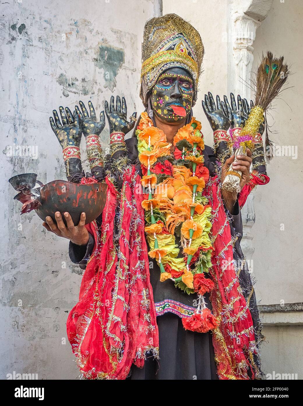 Young boy dressed as Kali, also known as the dark goddess, appears as a ...