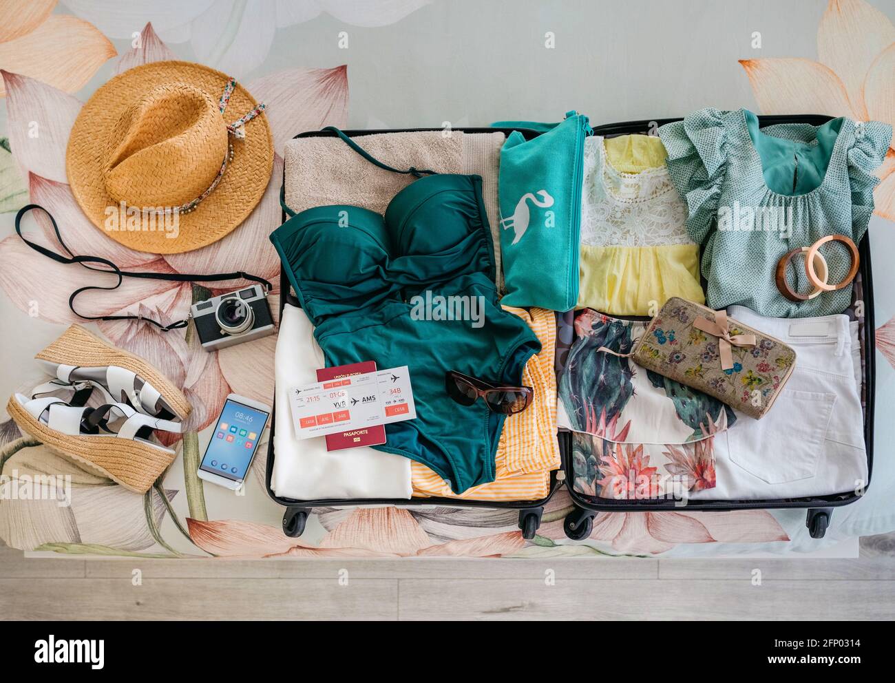 Open woman suitcase prepared for summer vacation Stock Photo - Alamy