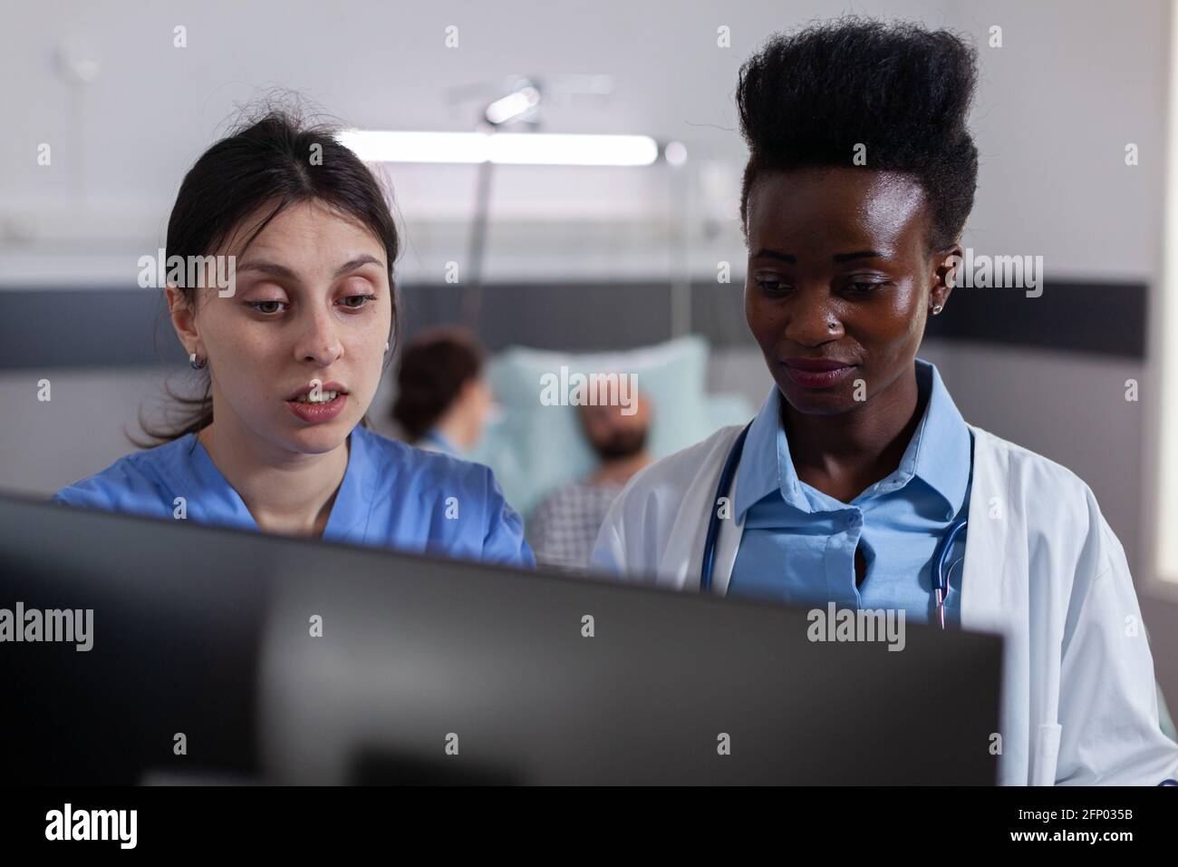 Afro american practitioner discussing recovery treatment with medical ...