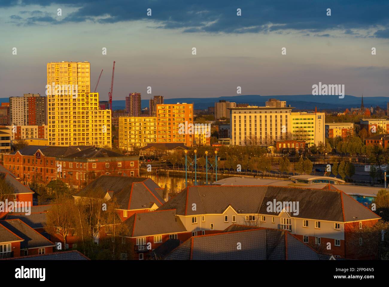 View of Manchester skyline and rooftops at sunset from Salford Quays ...