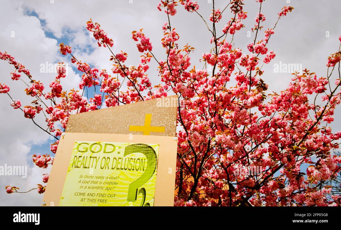 Cherry tree and religious poster Stock Photo - Alamy