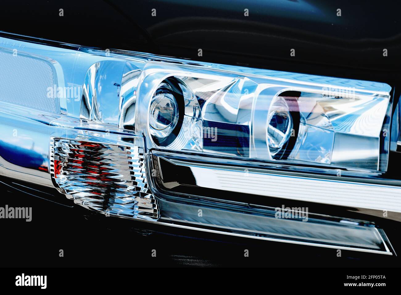 Crystal optics of the SUV. Front lights of a passenger car close-up. A ...