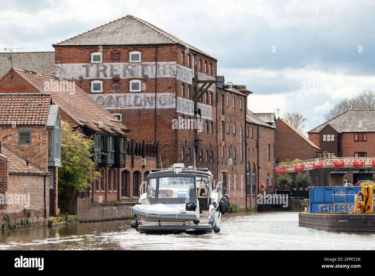 A modern stylish motor boat passing through Newark Town Lock Stock ...