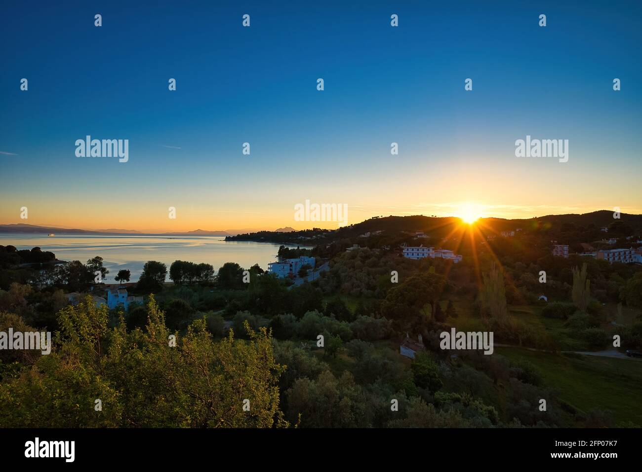 Aerial shot of the Greek Skiathos Island during a beautiful sunset ...