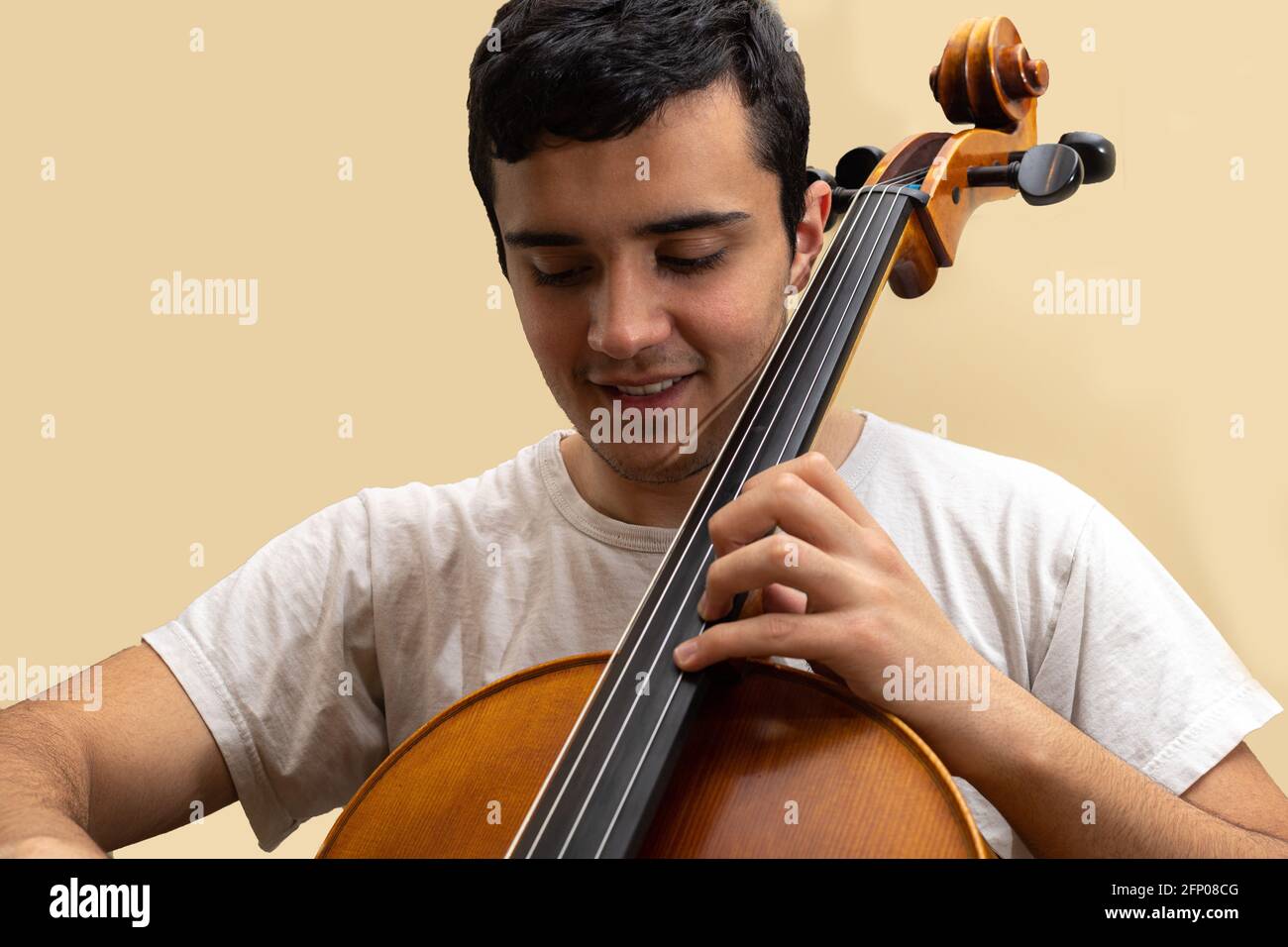Young teenage girl smiling and playing fretted string musical ...