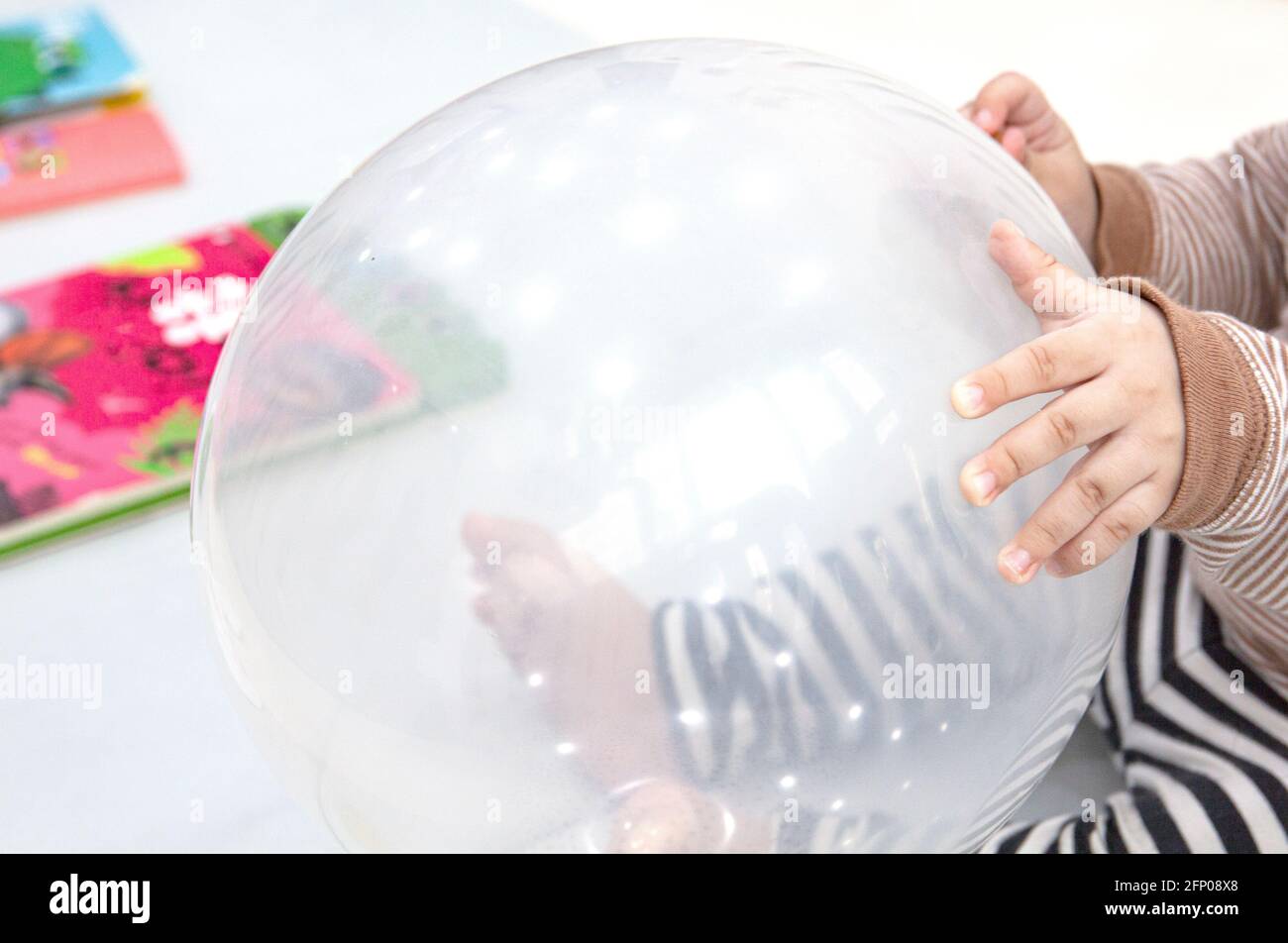 A large white balloon in the child's hand Stock Photo - Alamy