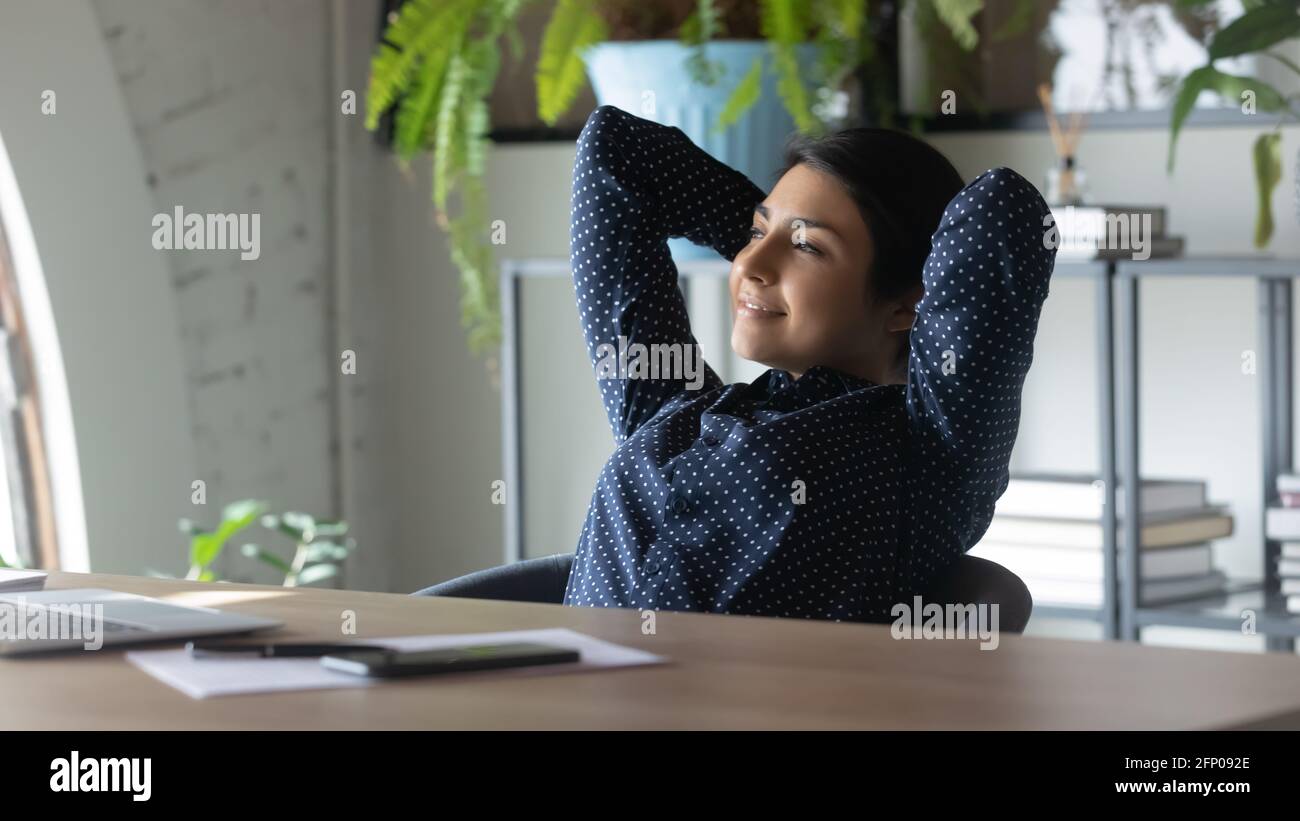 Indian female employee relax at workplace dreaming Stock Photo - Alamy