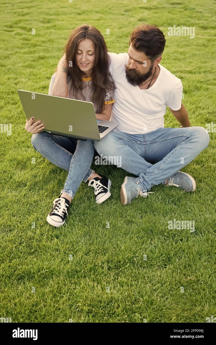 Girl and hipster man with laptop outdoors, web development concept ...