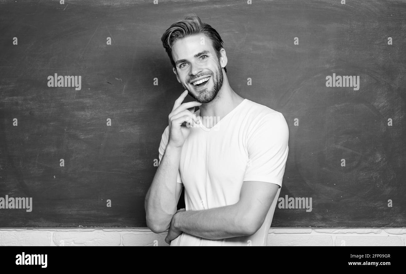 Master of simplification. Man teacher in front of chalkboard. Back to ...