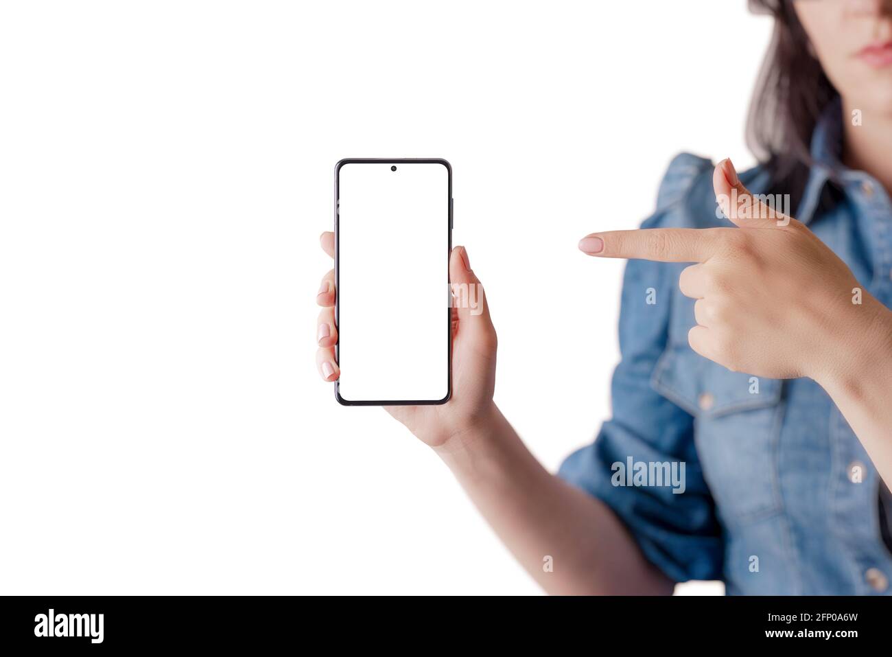 Woman holds and show a smart phone with a pointed finger. Isolated ...