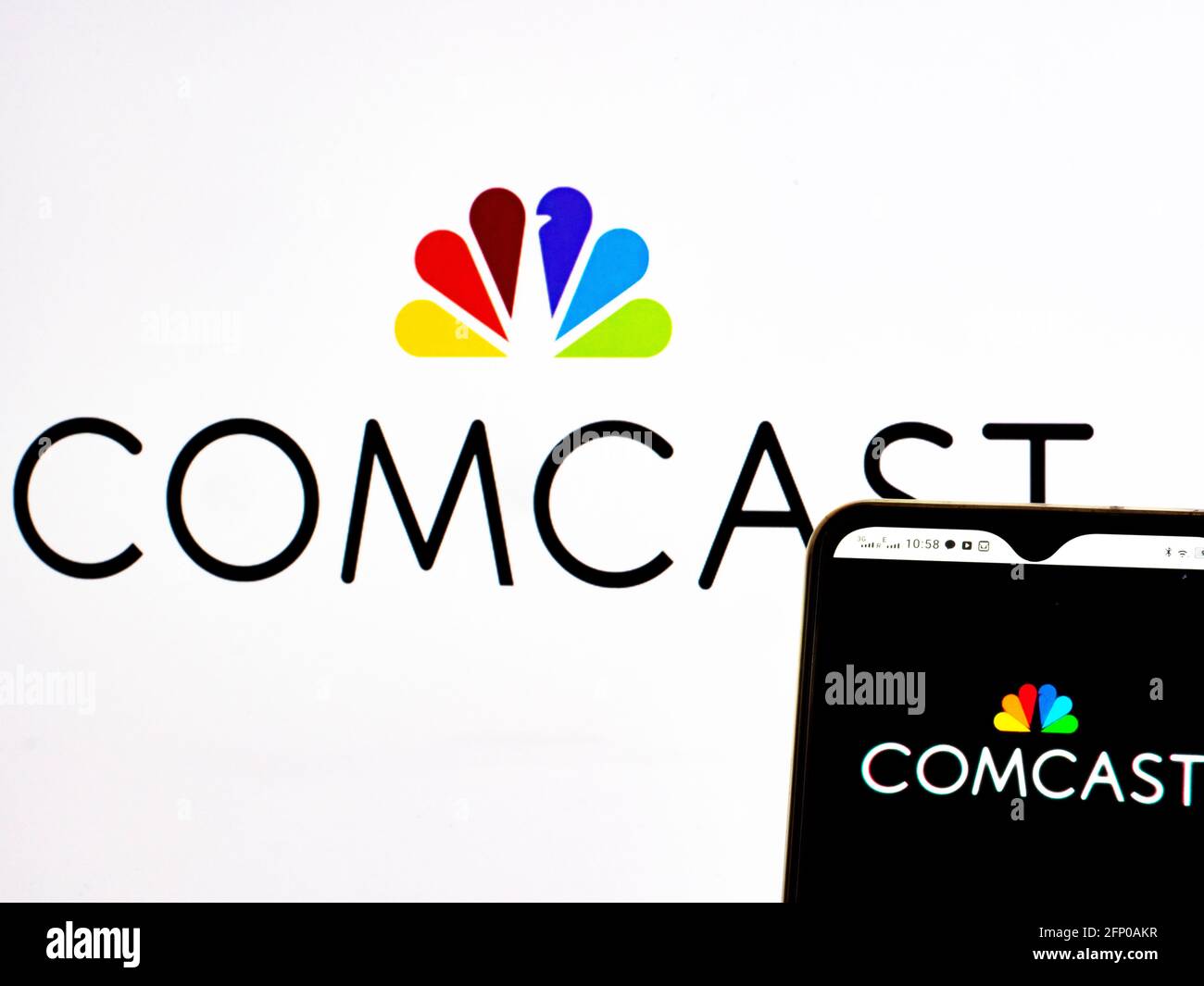 In this photo illustration Comcast Corporation logo seen displayed on a ...