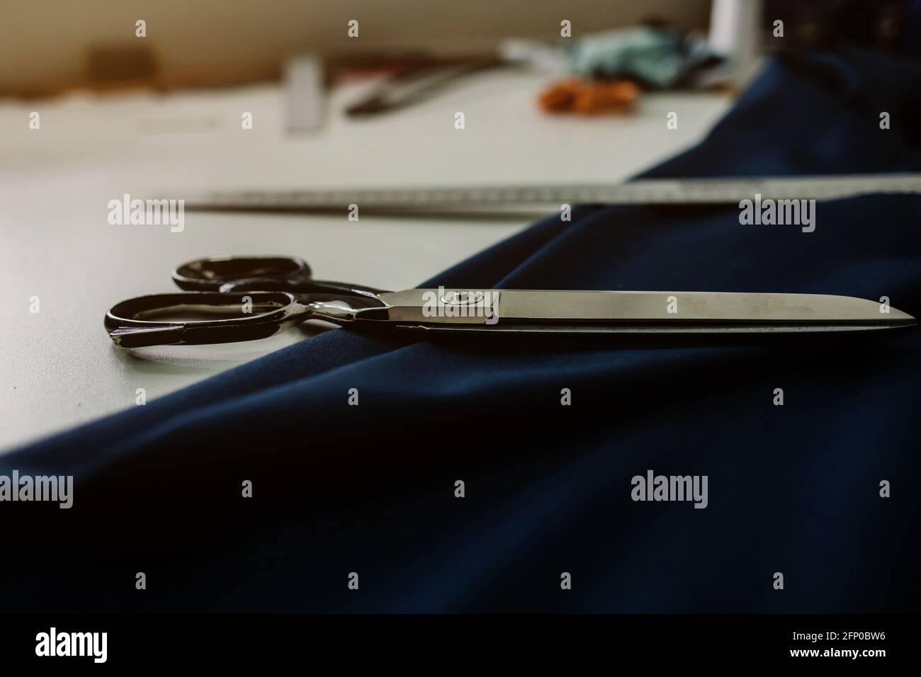 Measuring and cutting textile or fine cloth. Work table of a tailor ...