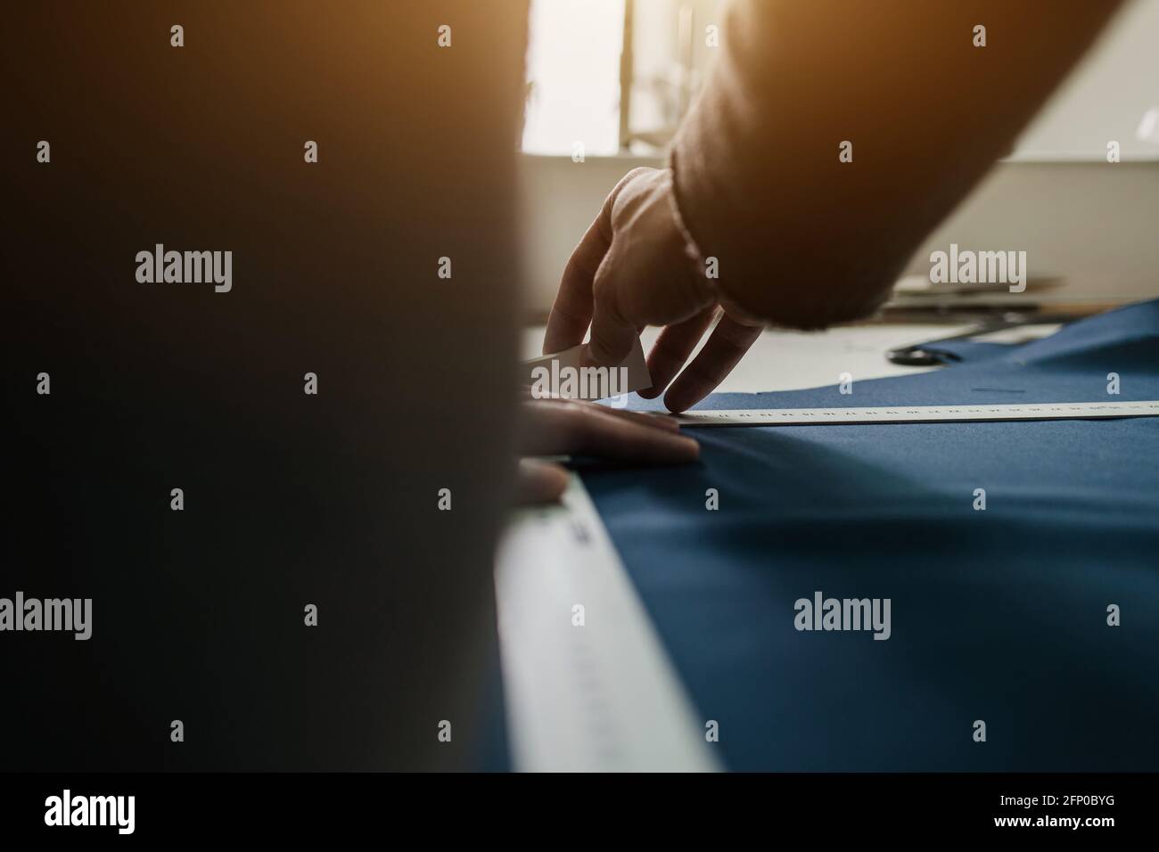 the tailor marks the lines on the clothes with chalk. private tailoring ...