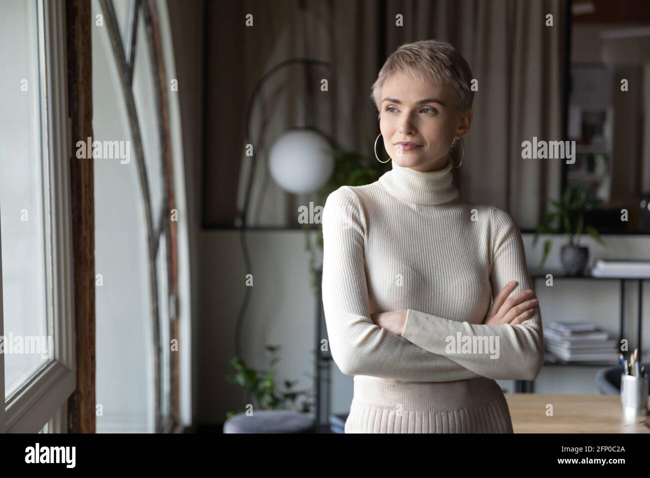 Pensive female employee look in distance thinking dreaming Stock Photo ...