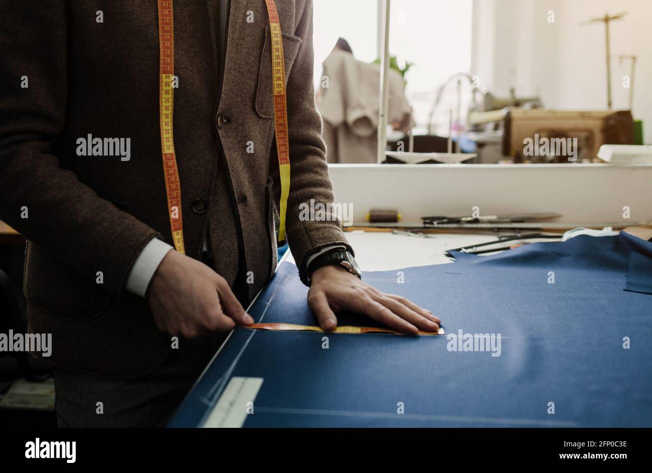 Tailor hands working with measure bar. handmade work. individual ...