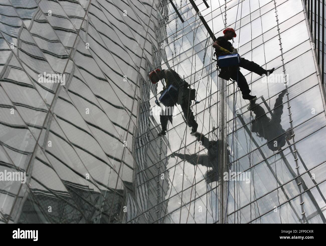 Belarus. Minsk - 22,06,2009: Worker, industrial climber, glass cleaning ...