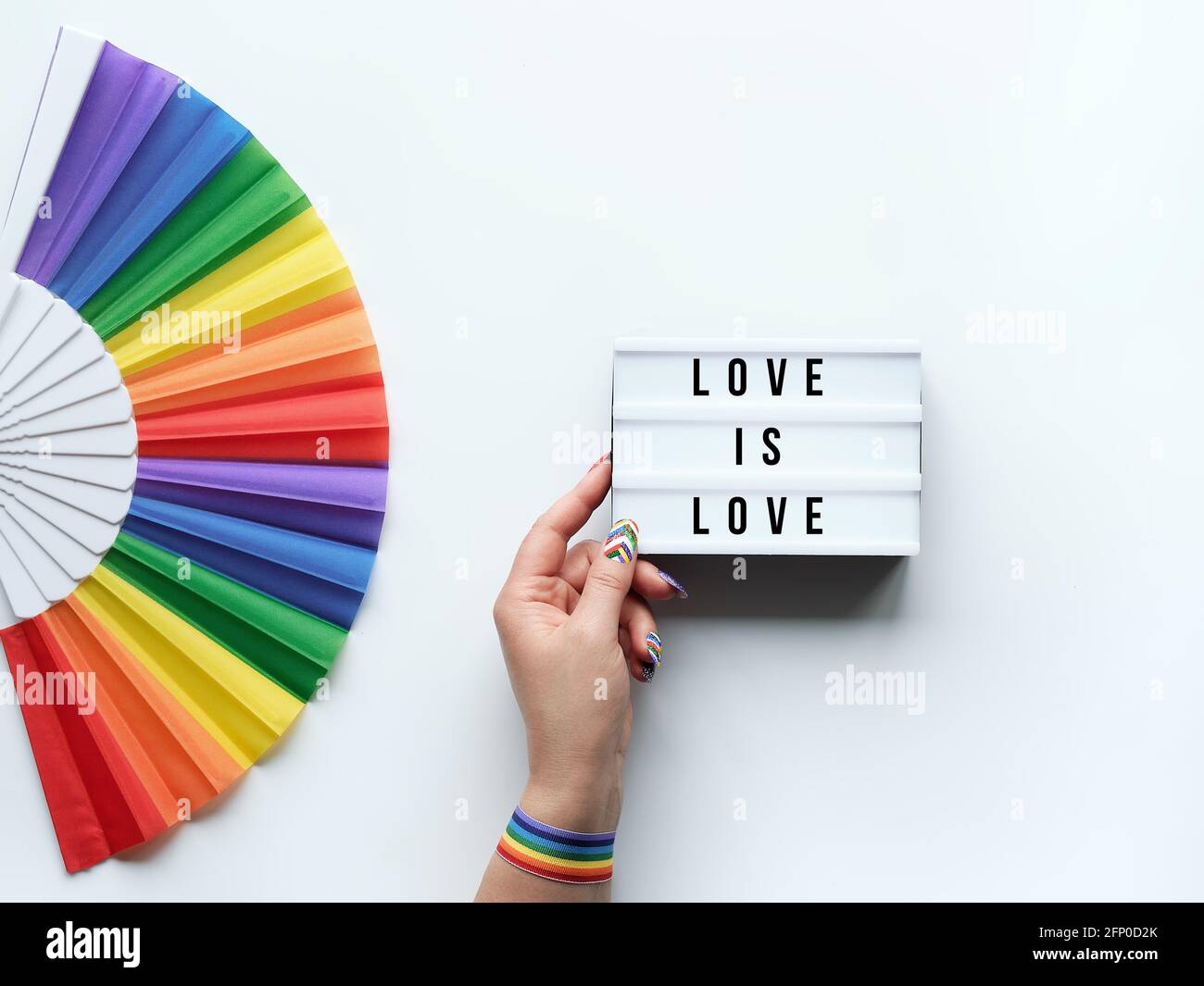 LGBTQ pride month decor. Text Love is Love on lightbox. Rainbow pattern ...