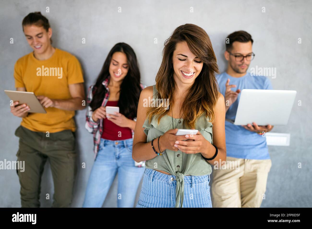 Happy young people working, using digital devices. Technology, people ...