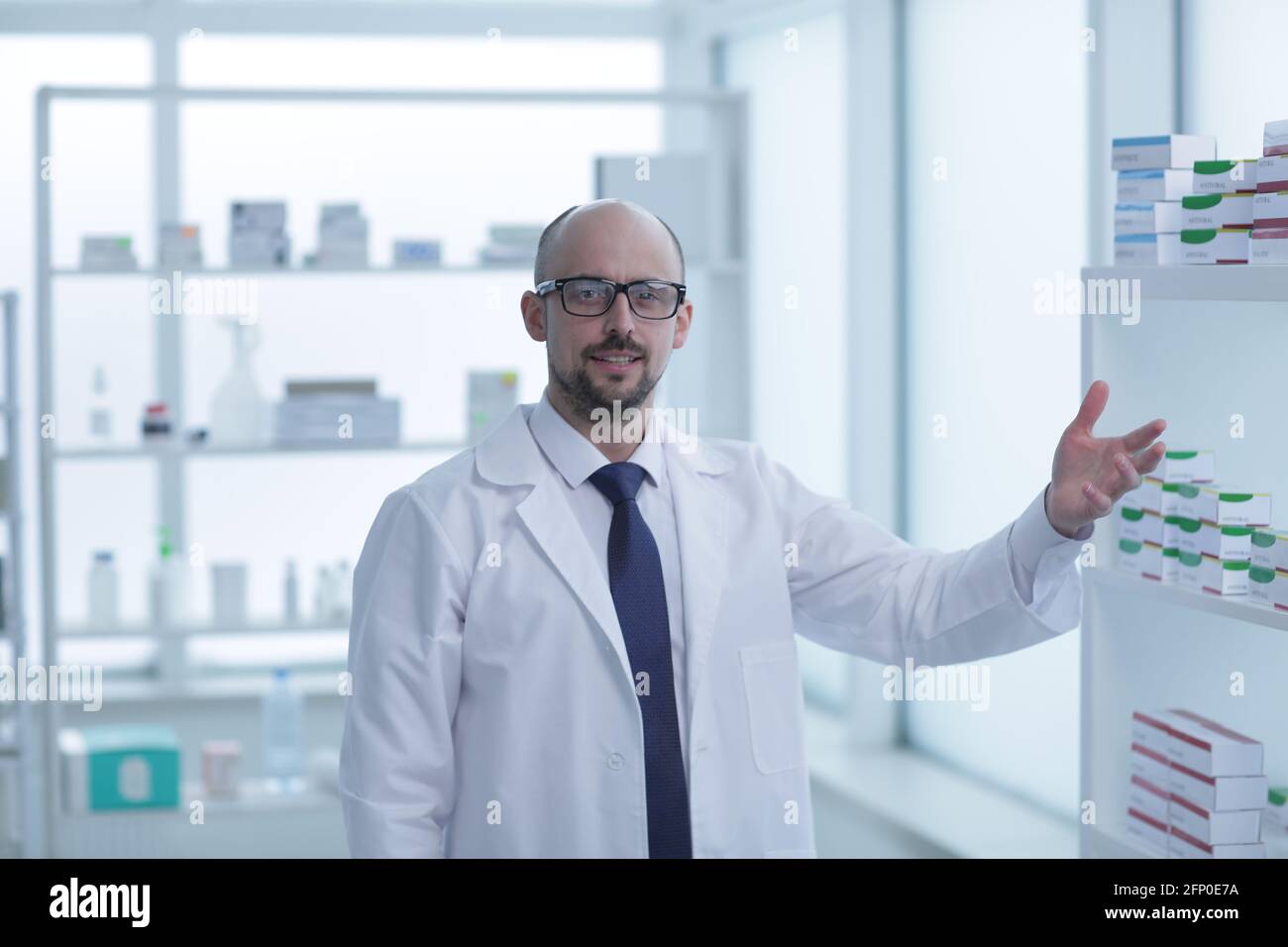 Pharmacist is working. Man wearing special uniform located in pharmacy ...
