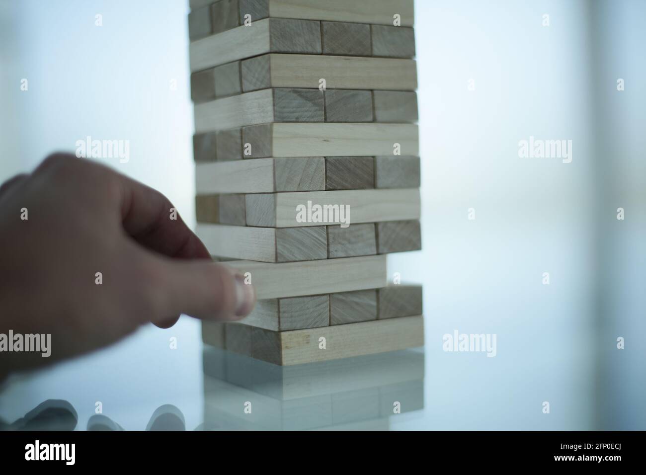 Wood Jenga on glass table Stock Photo - Alamy