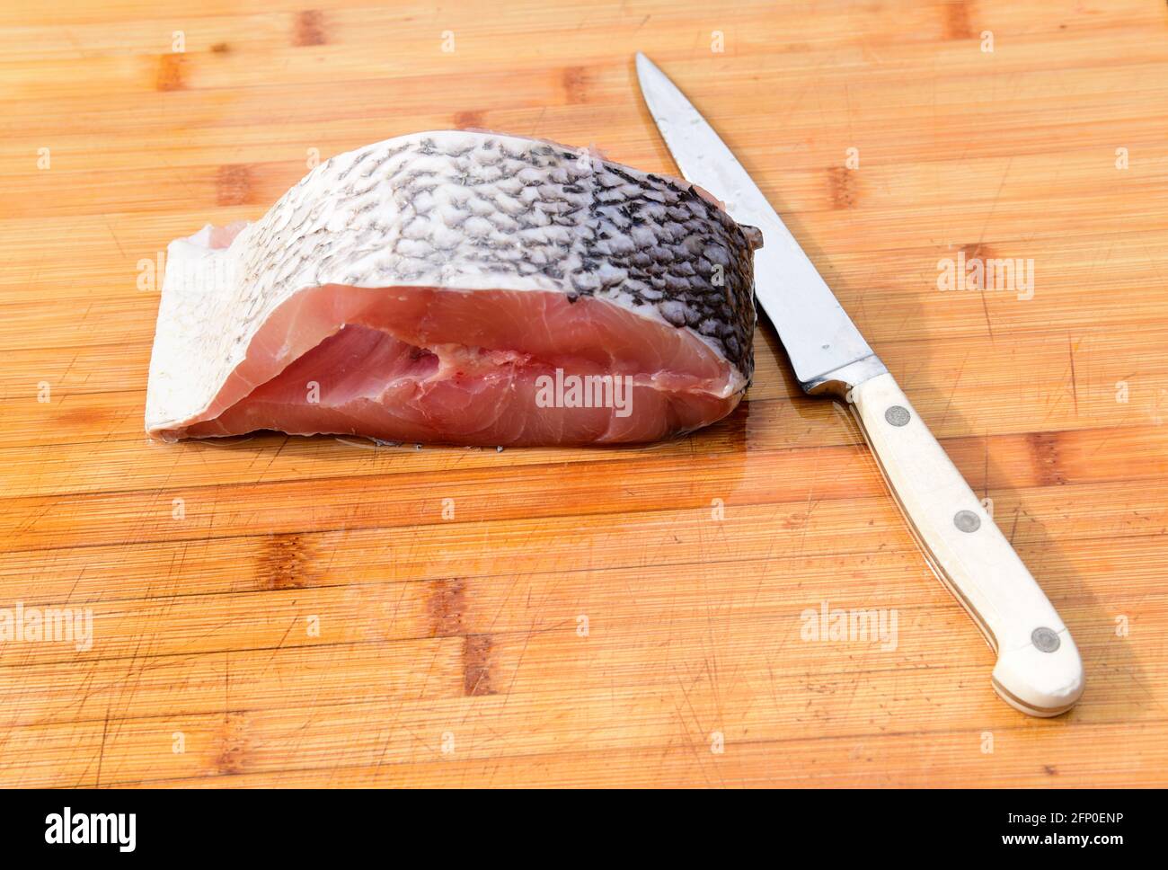 a piece of grouper fish cleaned and ready to be seasoned and cooked ...