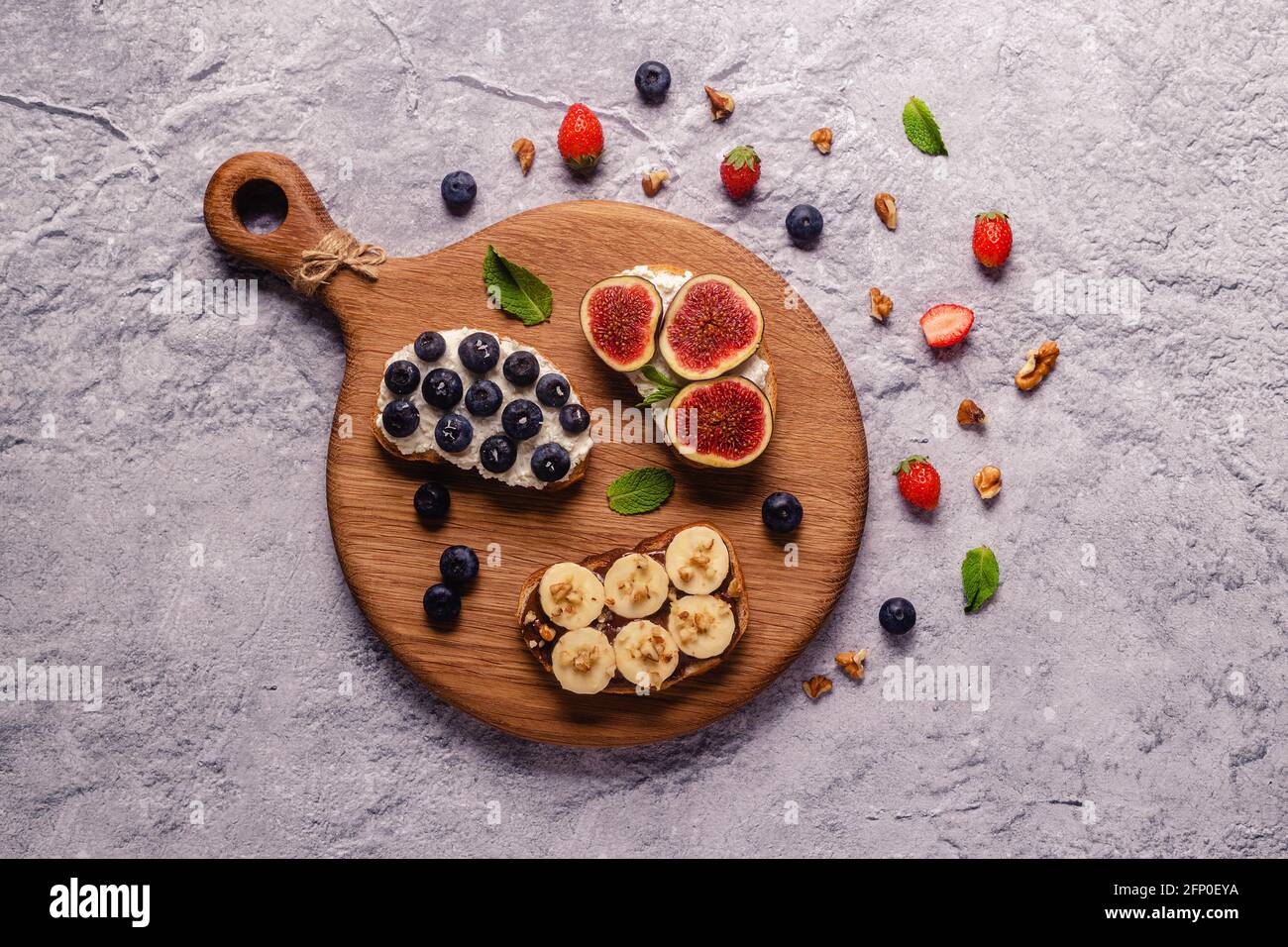 Homemade summer toast with cream cheese, nut butter and fruits and ...