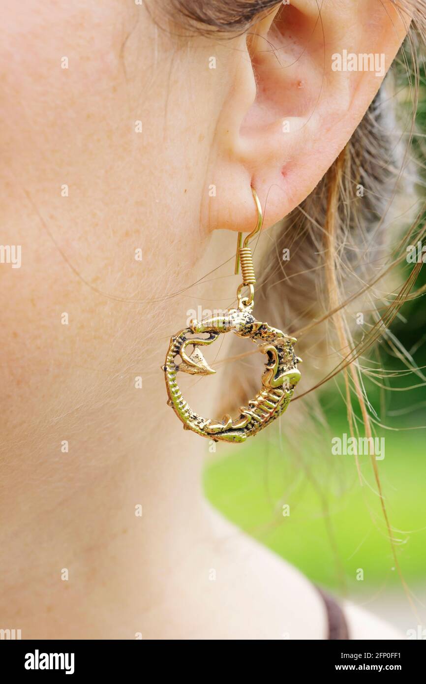 Outdoor detail of female ear wearing metal round shape earring Stock ...