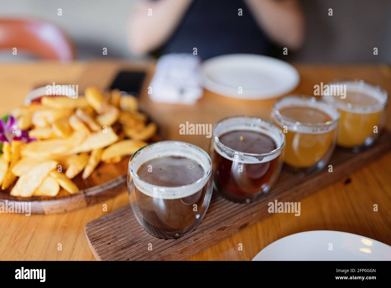 Man sampling variety of seasonal craft beer in pub. Beer samplers in ...