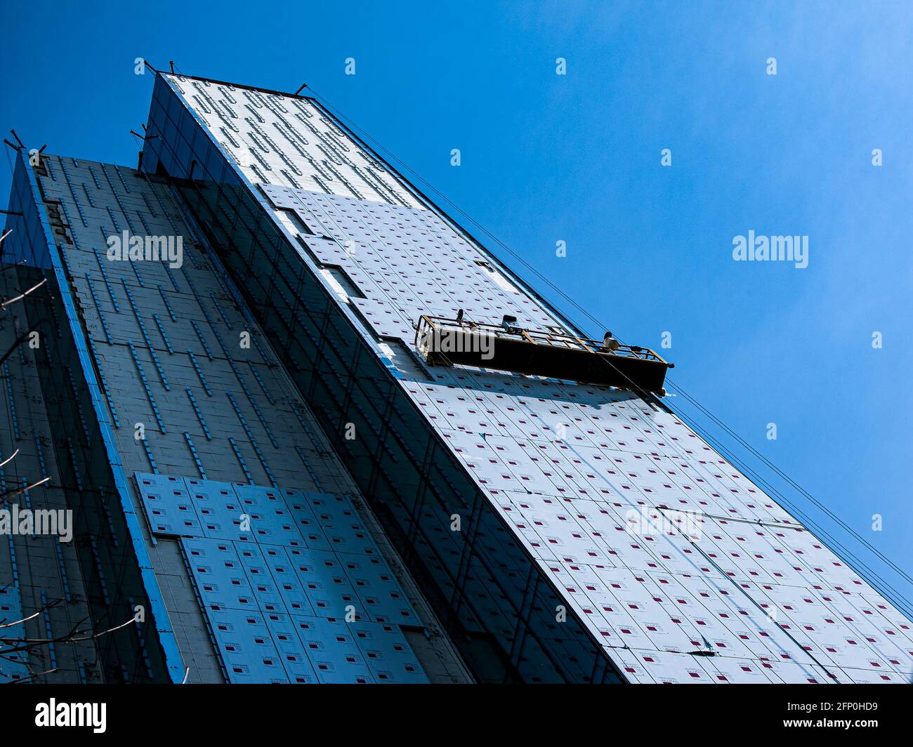 Construction of a multi-storey building. High-rise outdoor finishing ...