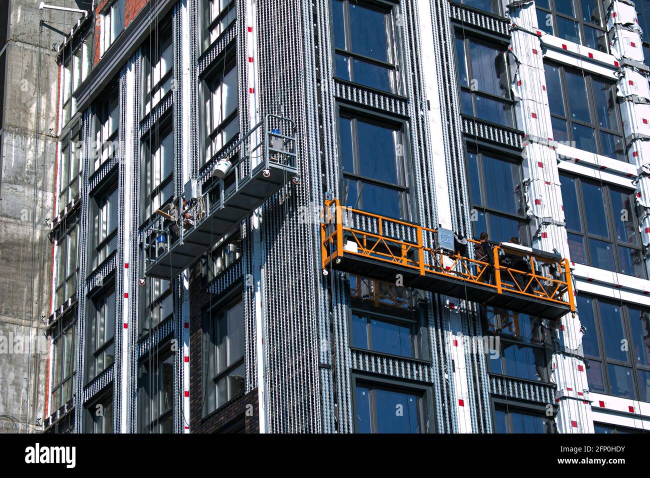 Construction of a multi-storey building. High-rise outdoor finishing ...