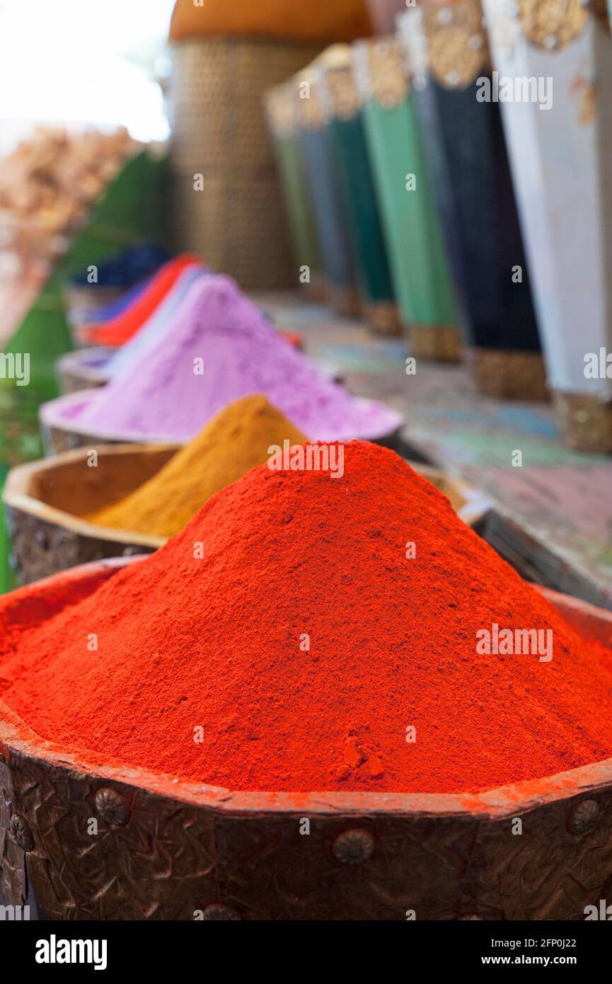 Vertical shot of vibrant color pigment powder in robust wooden ...