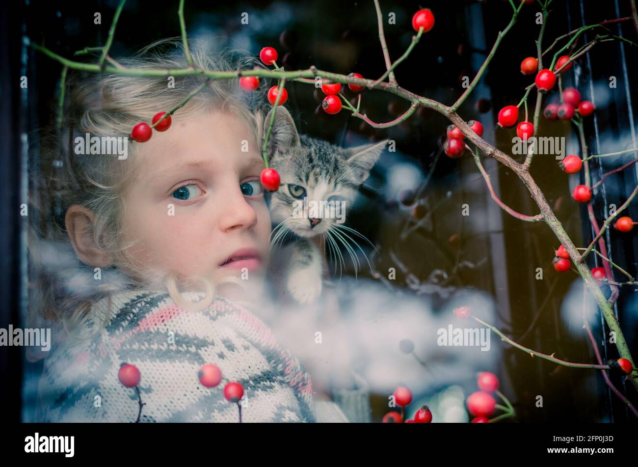 child with scared expression looking through window Stock Photo - Alamy