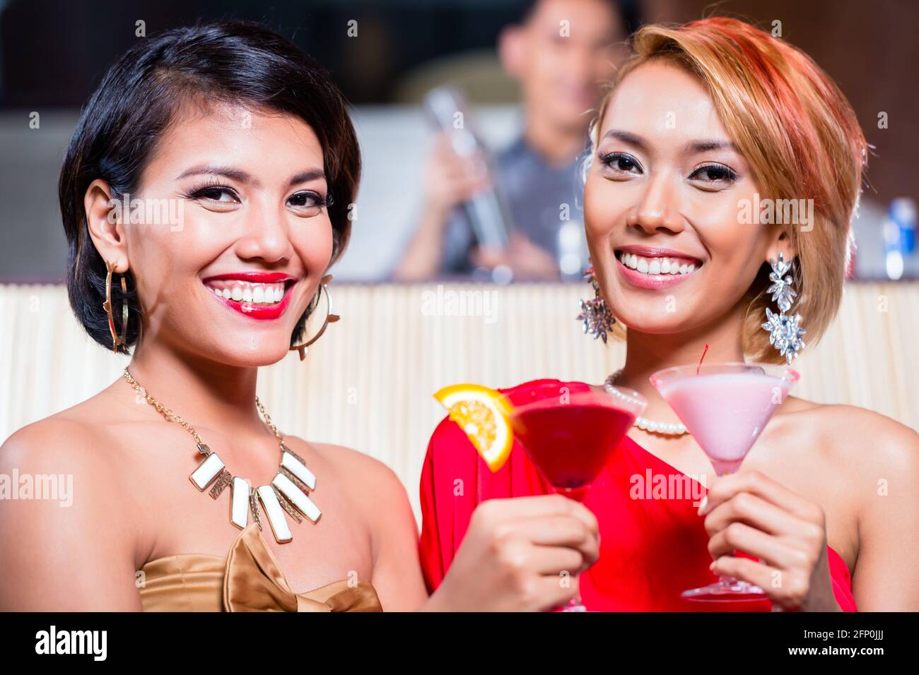 Asian women drinking cocktails in fancy bar Stock Photo - Alamy
