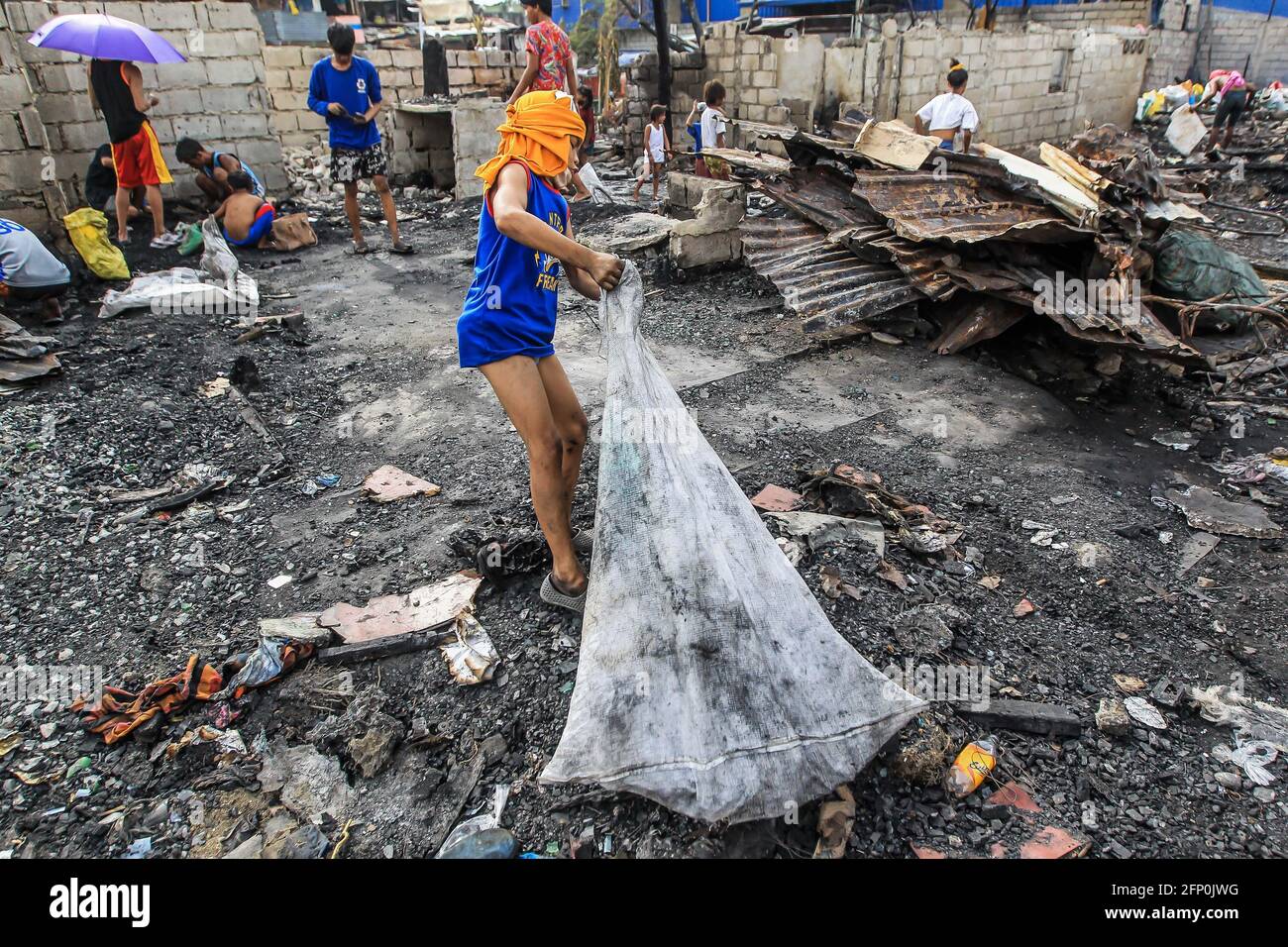Pasig City. 20th May, 2021. Residents search for their belongings ...