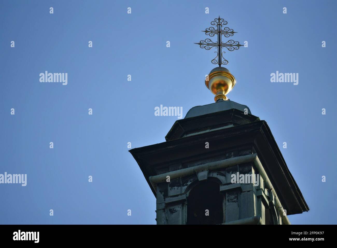 Baroque style bell tower architectural detail with a religious symbol ...