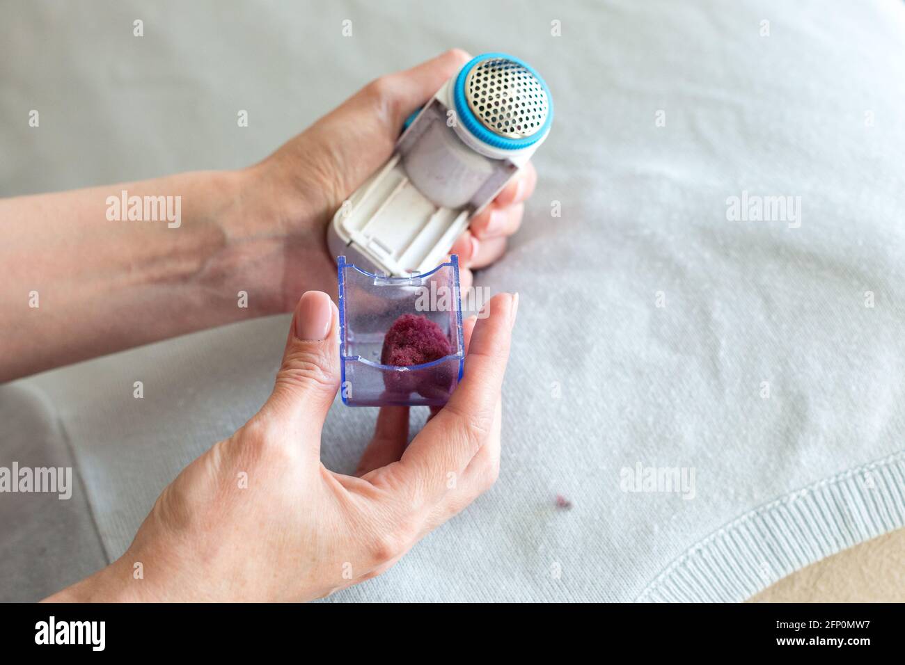 A woman disassembles, cleans the device for removing pellets Stock ...
