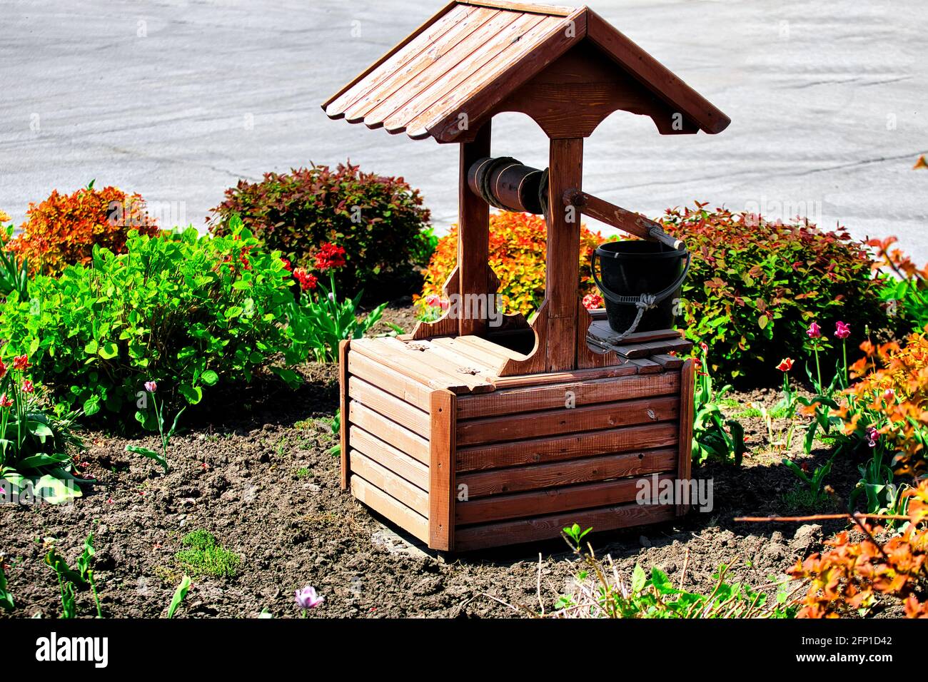 Decorative rustic wood well and flower bed. The idea for landscaping ...