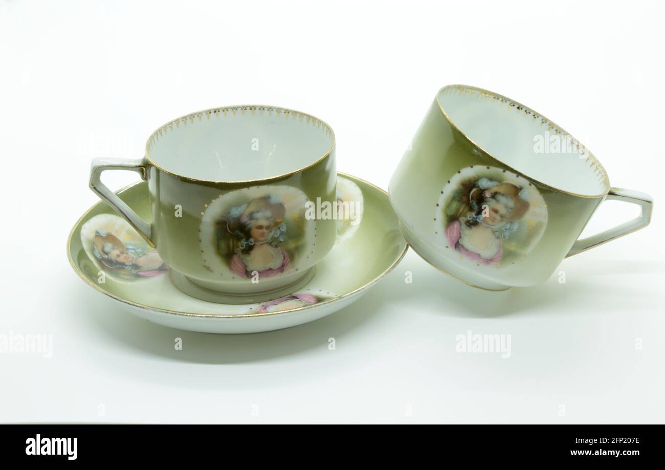 An antique and fragile coffee cup and saucer isolated on white ...