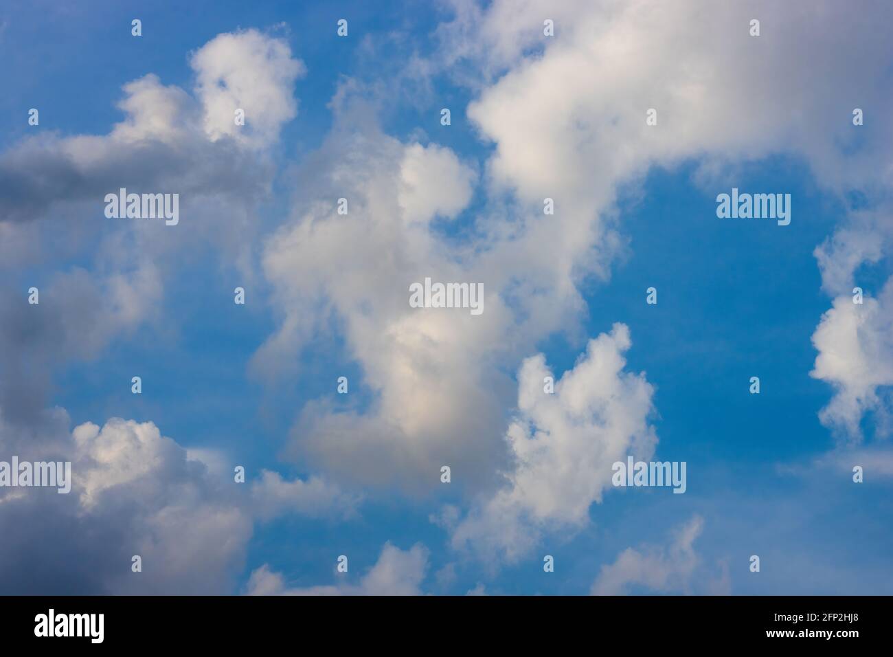 White clouds moving under the sunny blue sky Stock Photo - Alamy