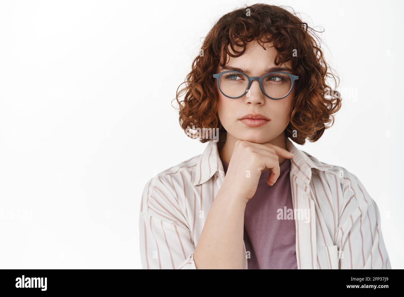 Serious thoughtful girl in glasses, student thinking, looking left at ...
