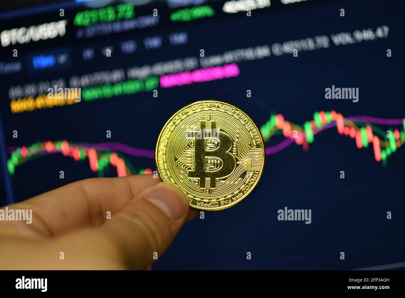 In this photo illustration a Bitcoin is seen on display with a Bitcoin ...