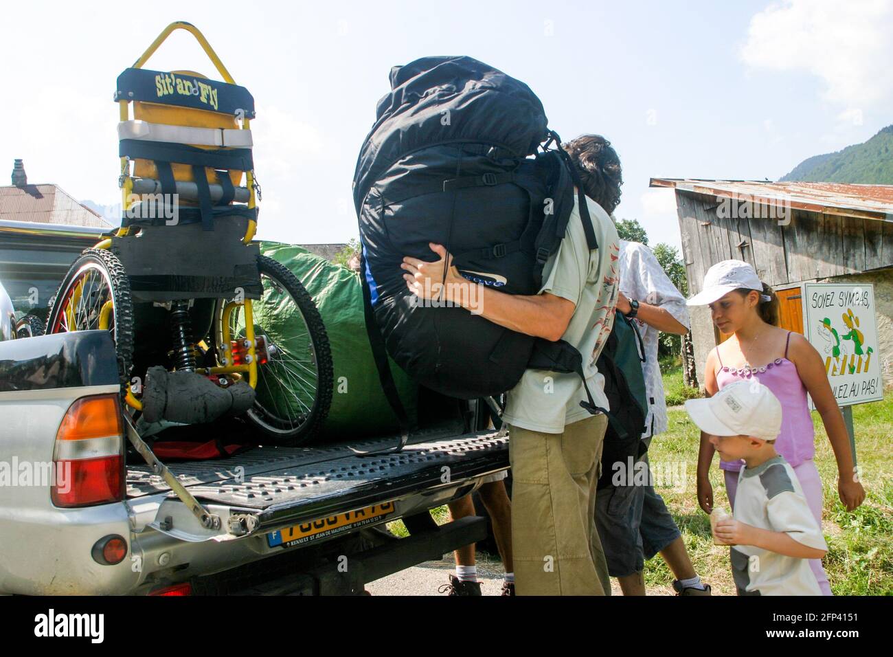 A young disabled child practices paraglider, seated in a special ...