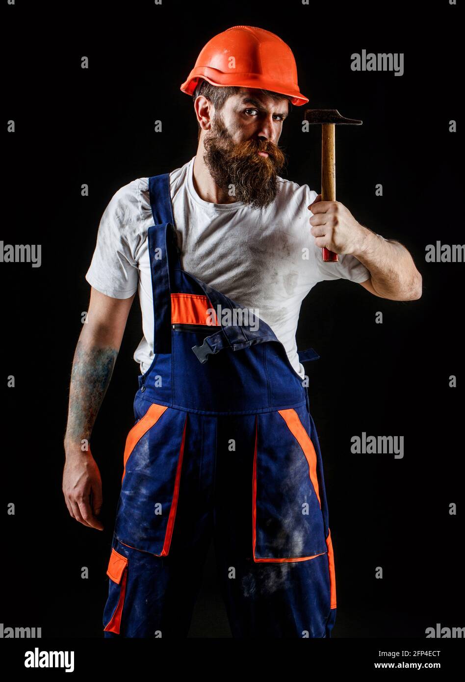 Bearded man worker with beard, building helmet, hard hat. Hammer ...