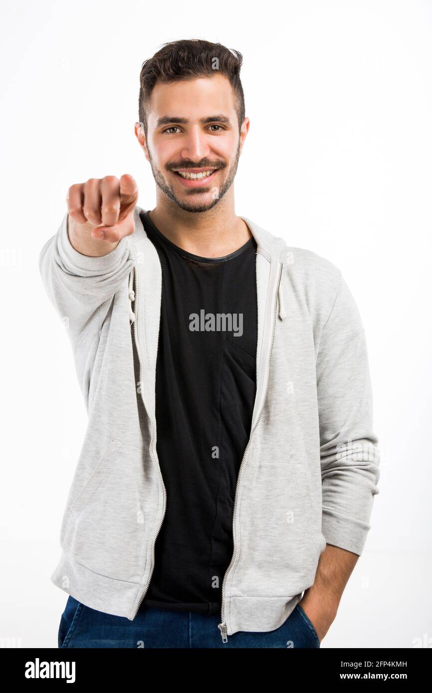 Successful young latin man pointing Stock Photo - Alamy