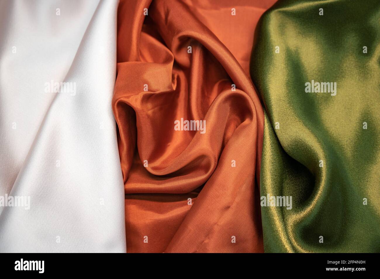 Three colors of folded fabric Stock Photo - Alamy