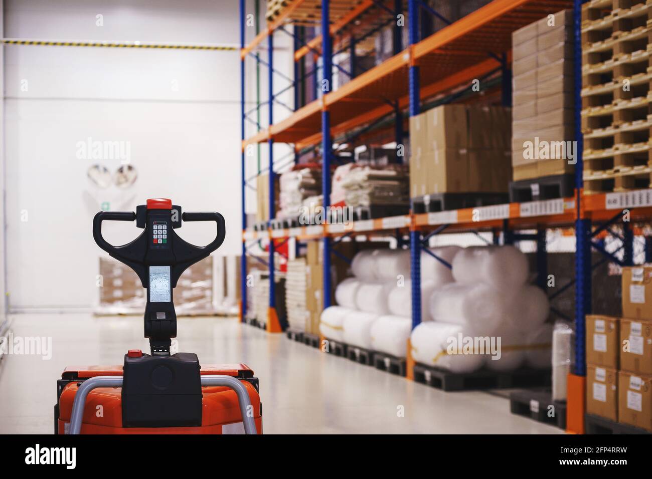 Electric forklift in modern warehouse with targeted storage system ...