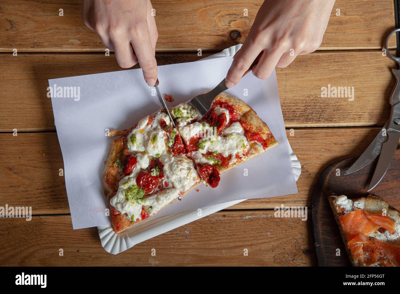 Aerial view of woman eating pizza Stock Photo - Alamy