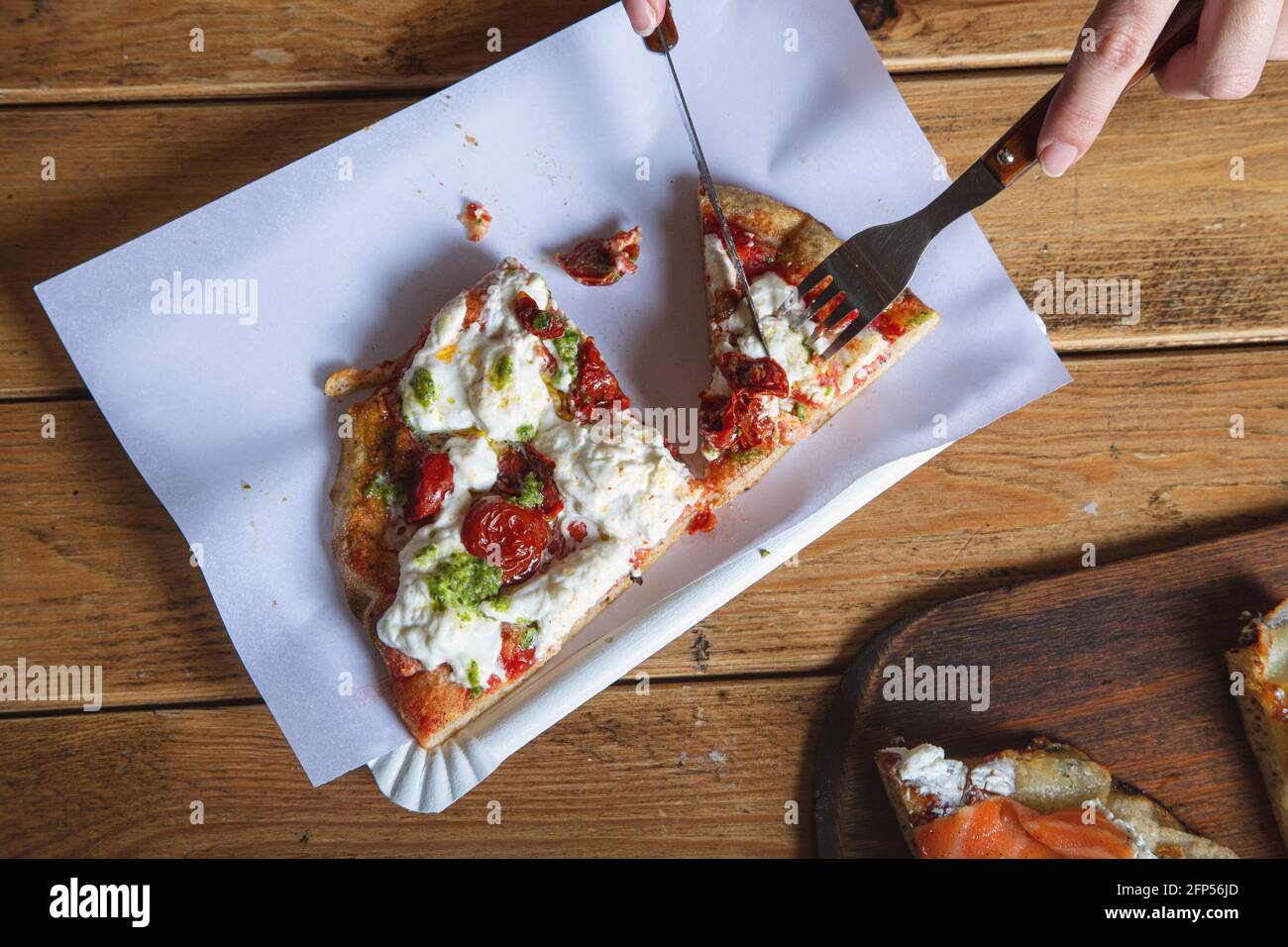 Aerial view of a woman's hands eating pizza Stock Photo - Alamy